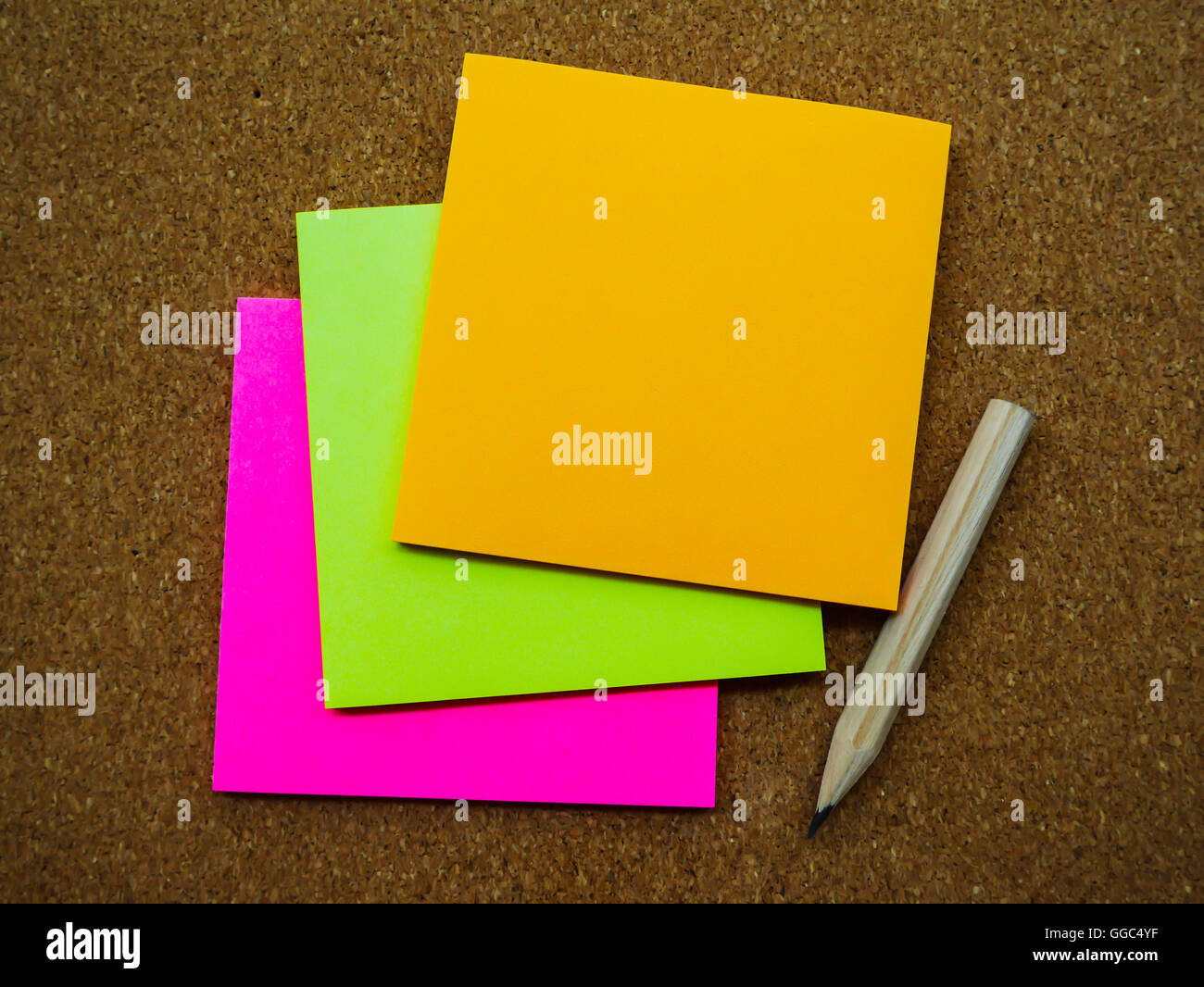Three post note and pencil on wooden board Stock Photo - Alamy