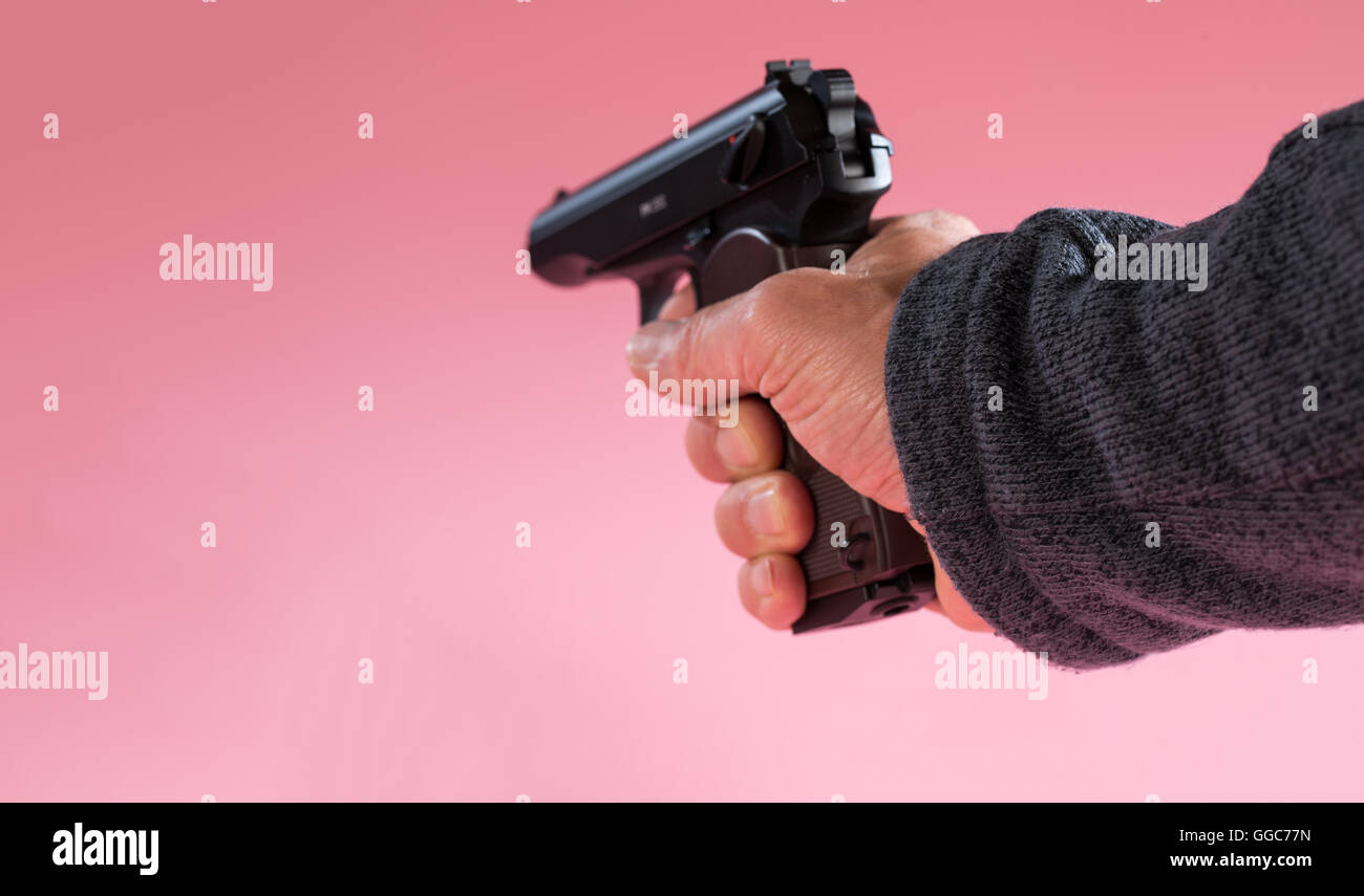 Mans hand holding gun hi-res stock photography and images - Alamy