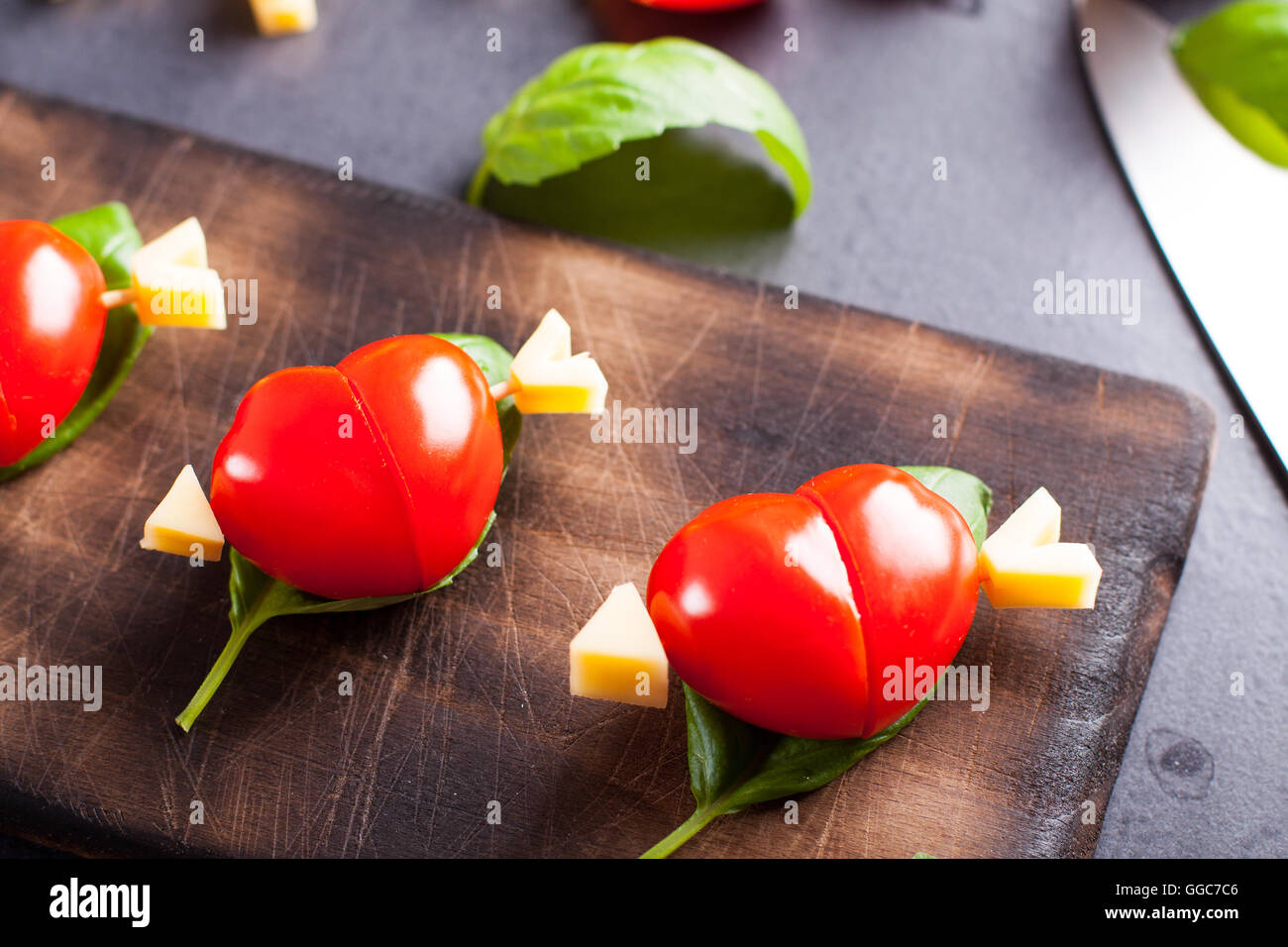 Marinated fillet with tomato heart shaped. Appetizer for a party ...