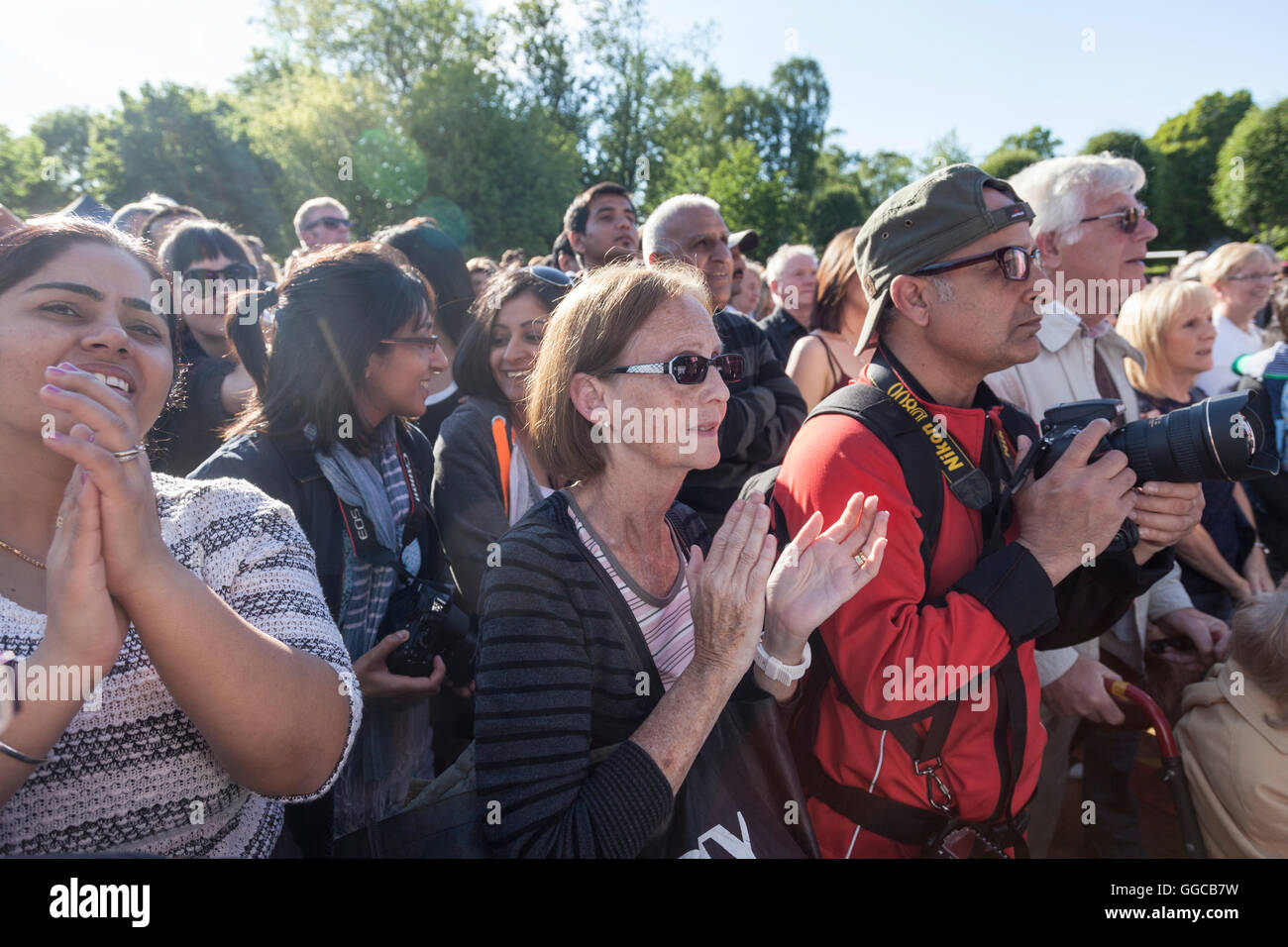 A multi-ethnic crowd intent on a performance during the Glasgow Mela, a ...