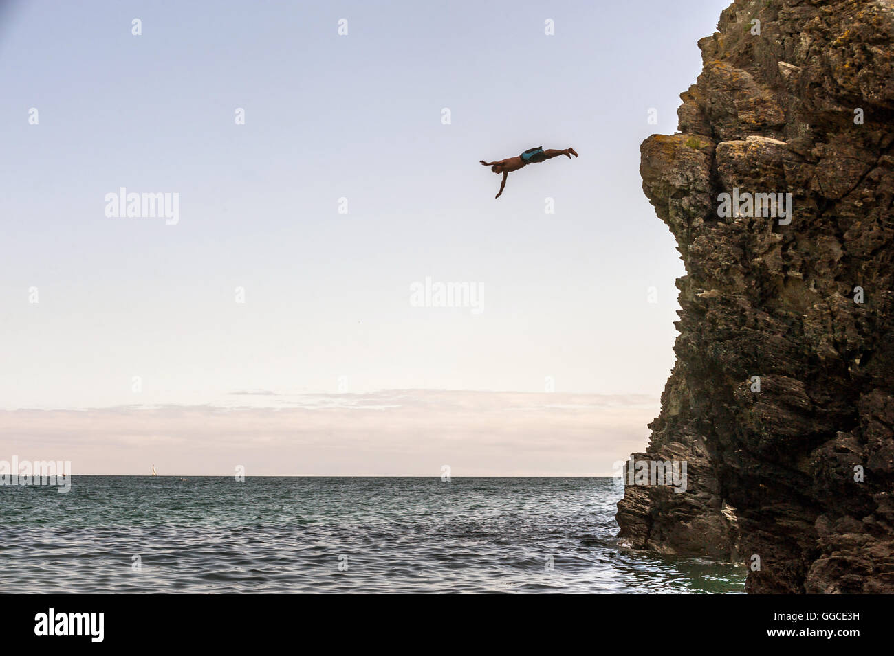 A cliff-diver diving into the sea on the south coast of England Stock ...