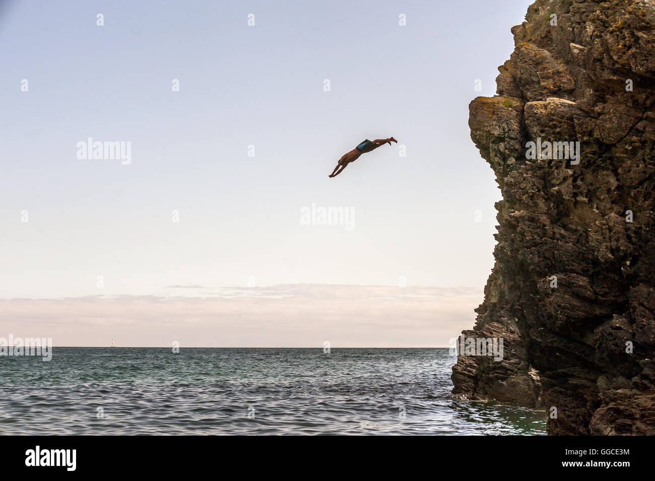 A cliff-diver diving into the sea on the south coast of England Stock ...