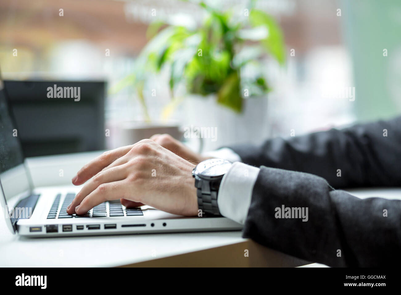 Hand of a business man while working on a laptop Stock Photo - Alamy