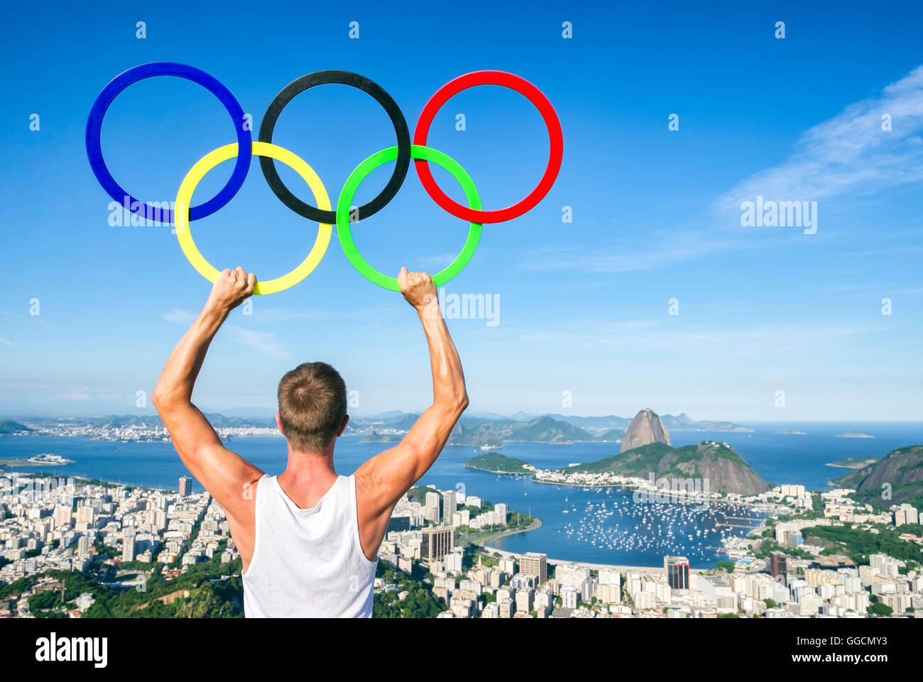 RIO DE JANEIRO - MARCH 21, 2016: Athlete holds Olympic rings under ...
