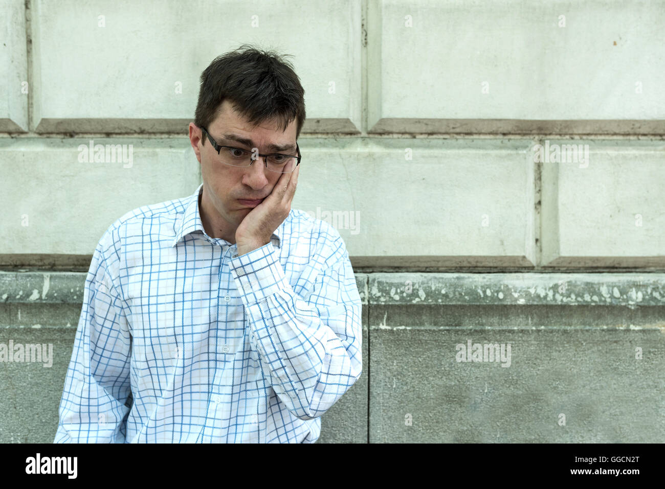 A adult man being worried and scared on the street Stock Photo - Alamy