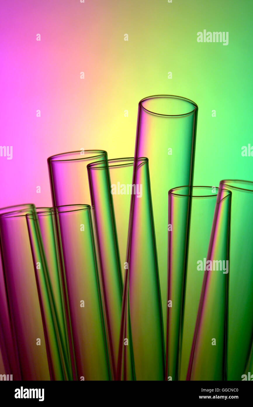 Laboratory glass test tubes over yellow with pink and green psychedelic ...