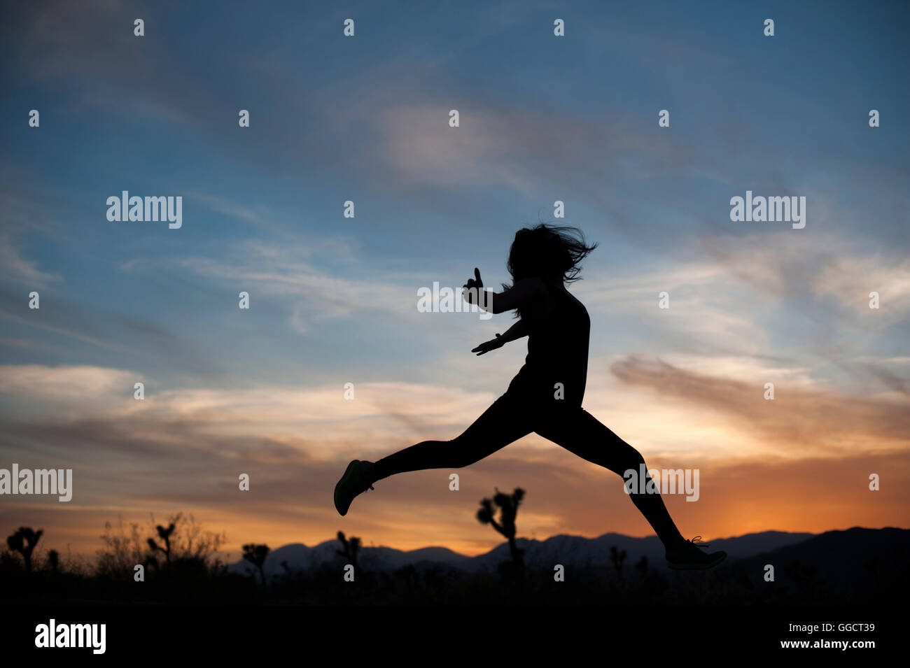 Woman dancing at sunset hi-res stock photography and images - Alamy