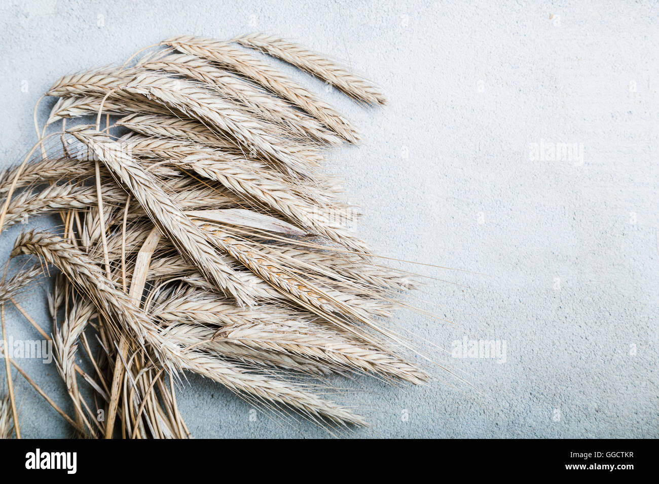 Ripe wheat on grey rustic background Stock Photo - Alamy