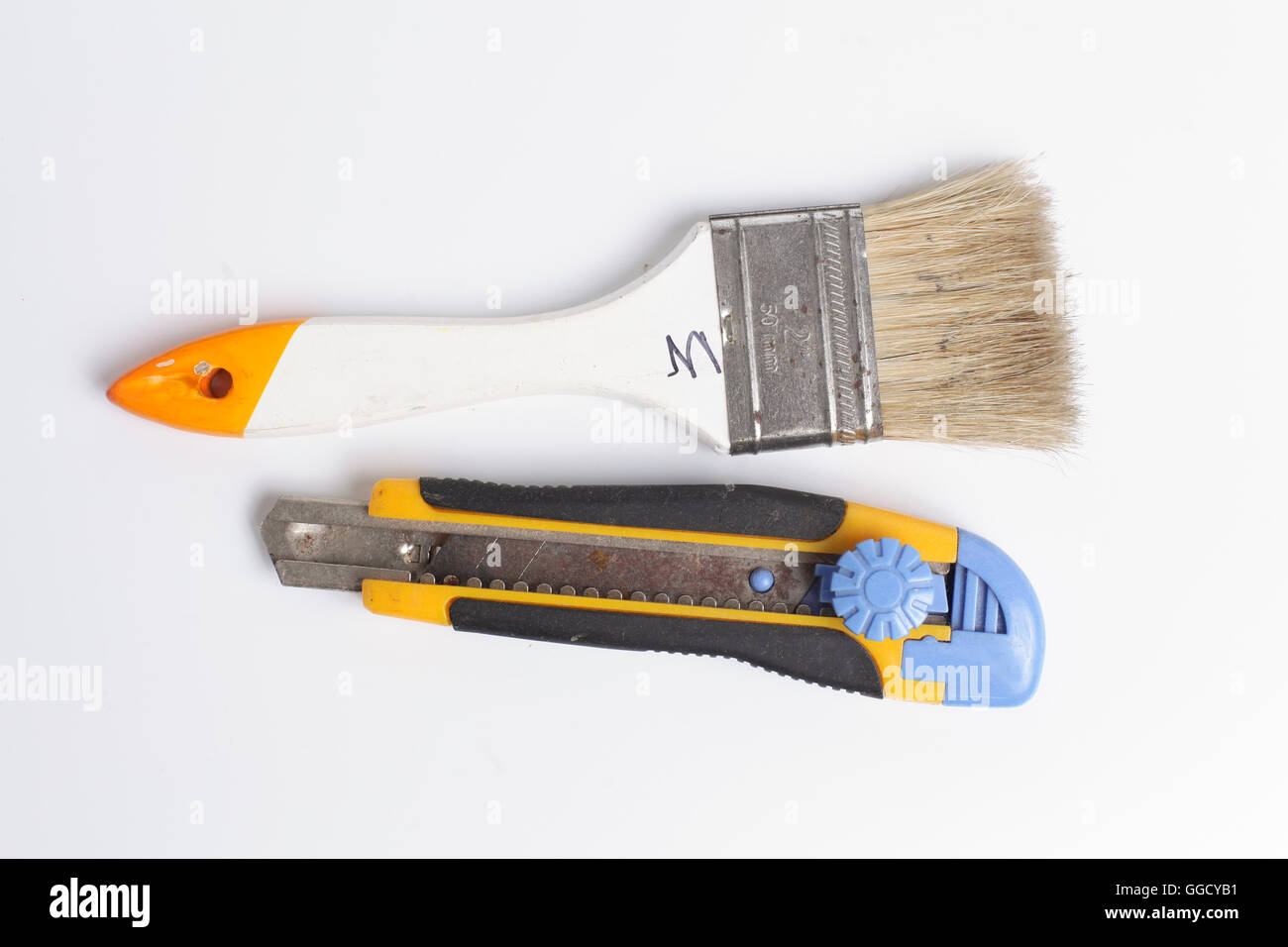 Paper cutting knife and clean paint brush isolated on white background ...