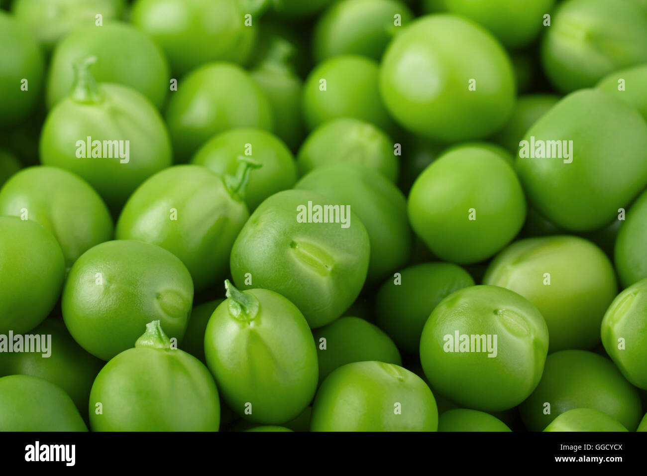 Young grean peas closeup view background Stock Photo - Alamy