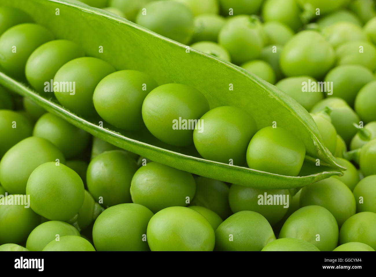 Young grean peas closeup view background Stock Photo - Alamy