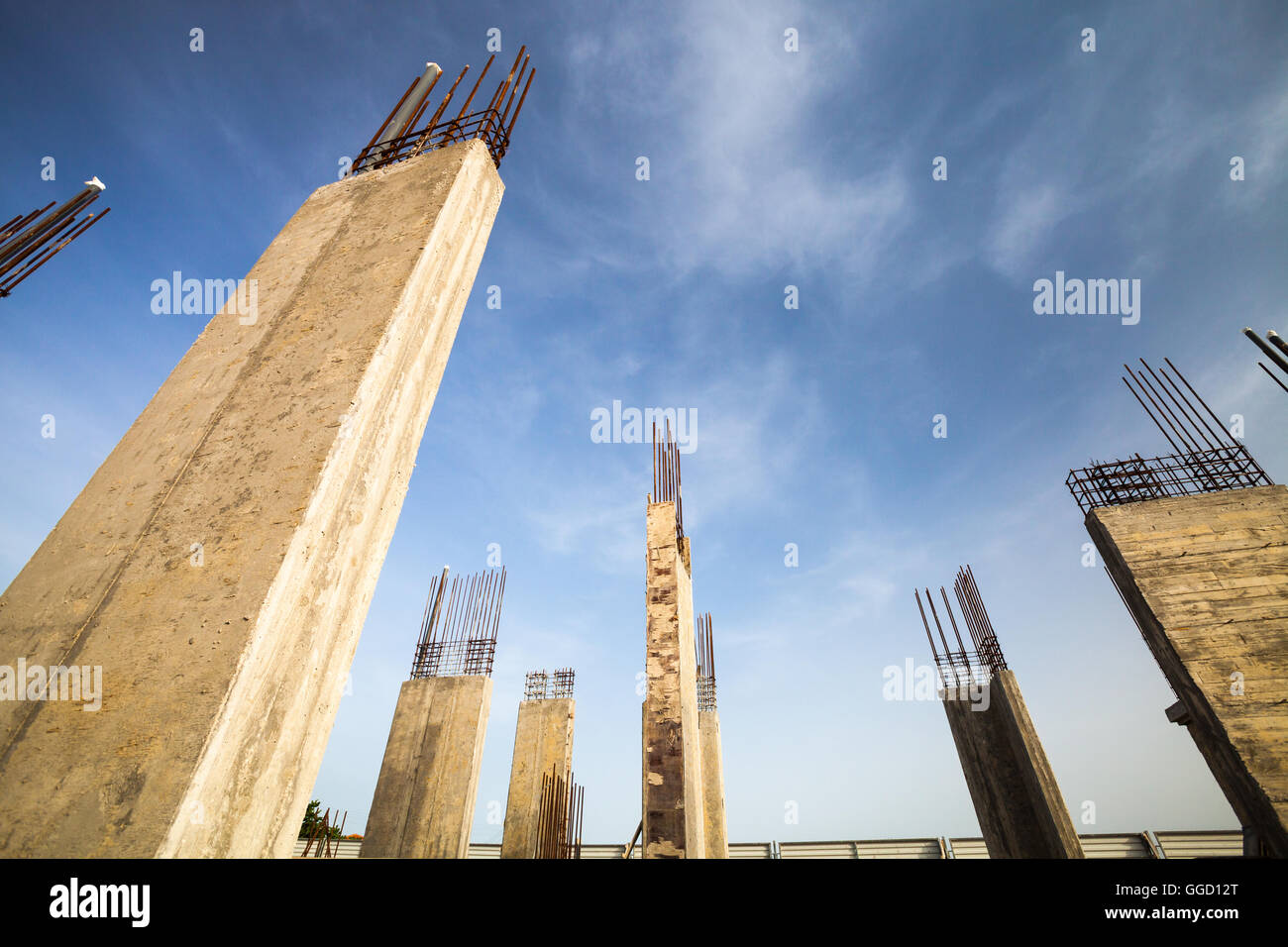 Construction site - Pillars of a building in the making against blue ...