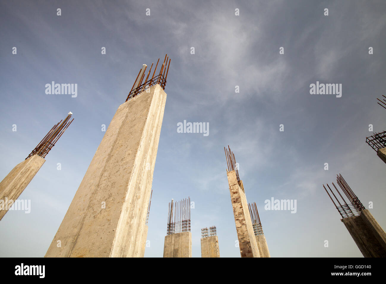 Construction site - Pillars of a building in the making against blue ...