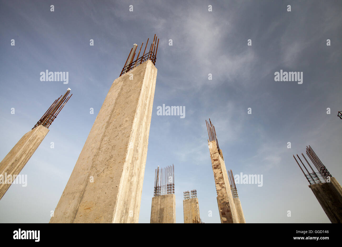 Construction site - Pillars of a building in the making against blue ...