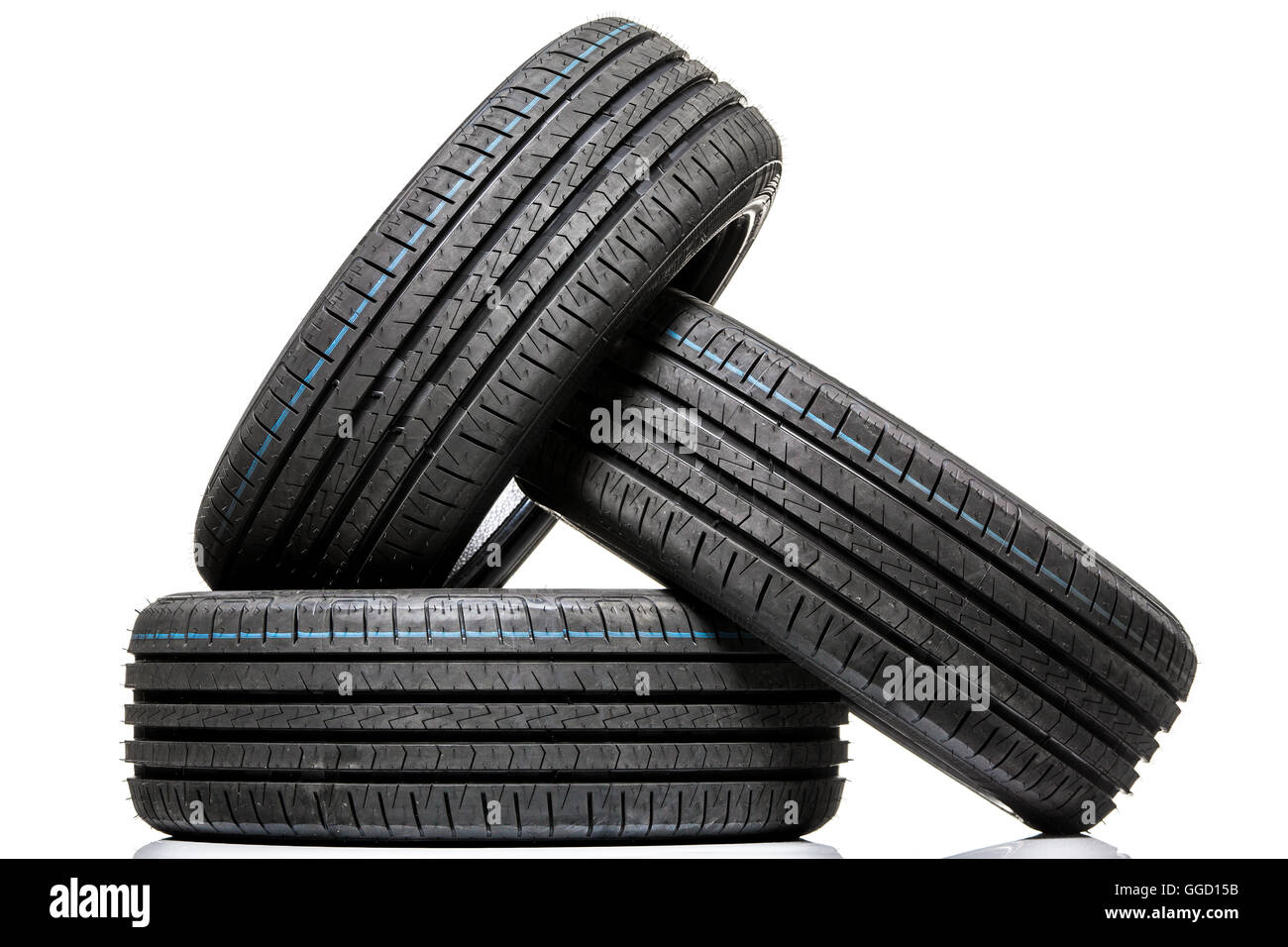 Stack of brand new high performance car tires on clean high-key white ...