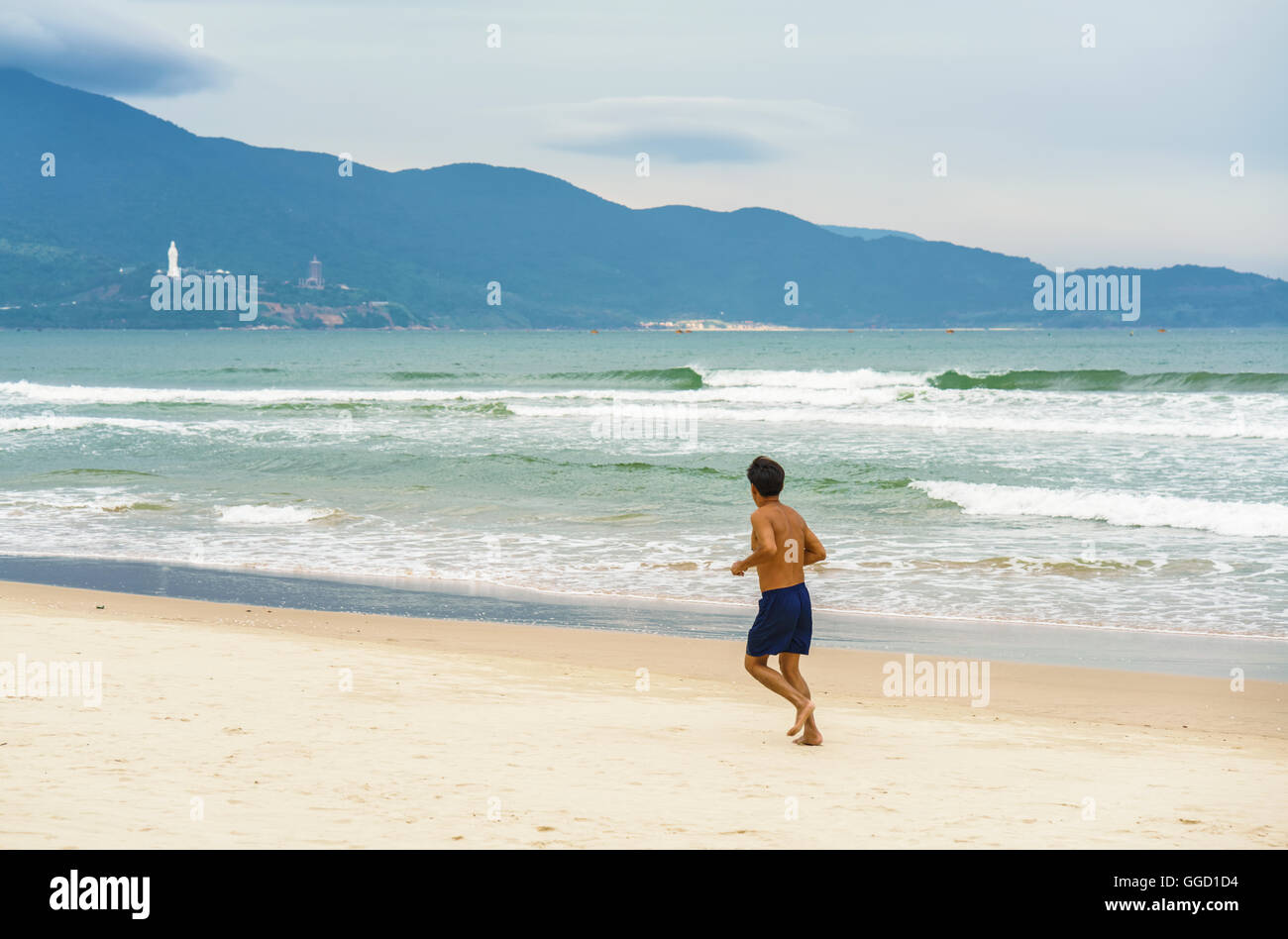 Man running near the China Beach in Danang in Vietnam. It is also ...
