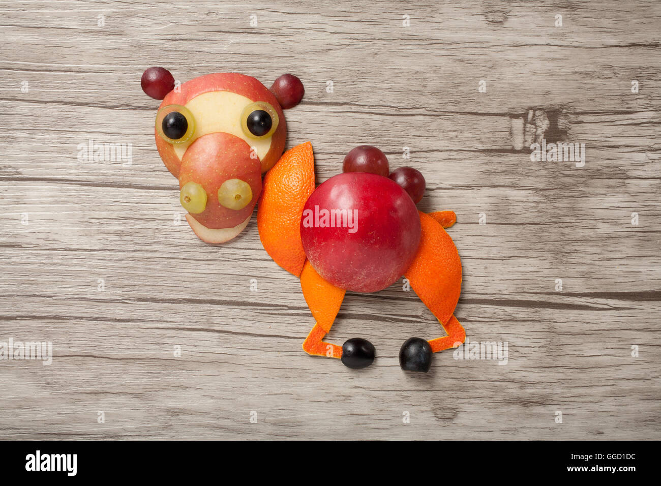 Funny camel made of apple on wooden background Stock Photo - Alamy
