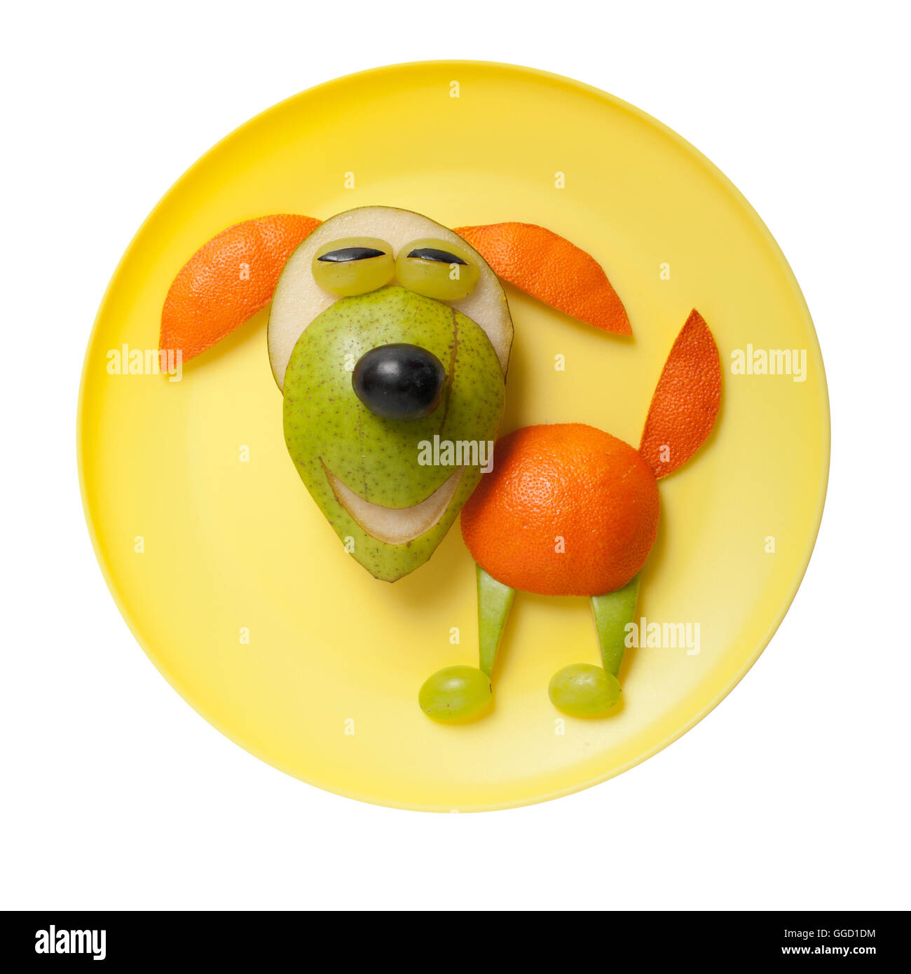 Smiling fruit dog made on yellow plate Stock Photo - Alamy
