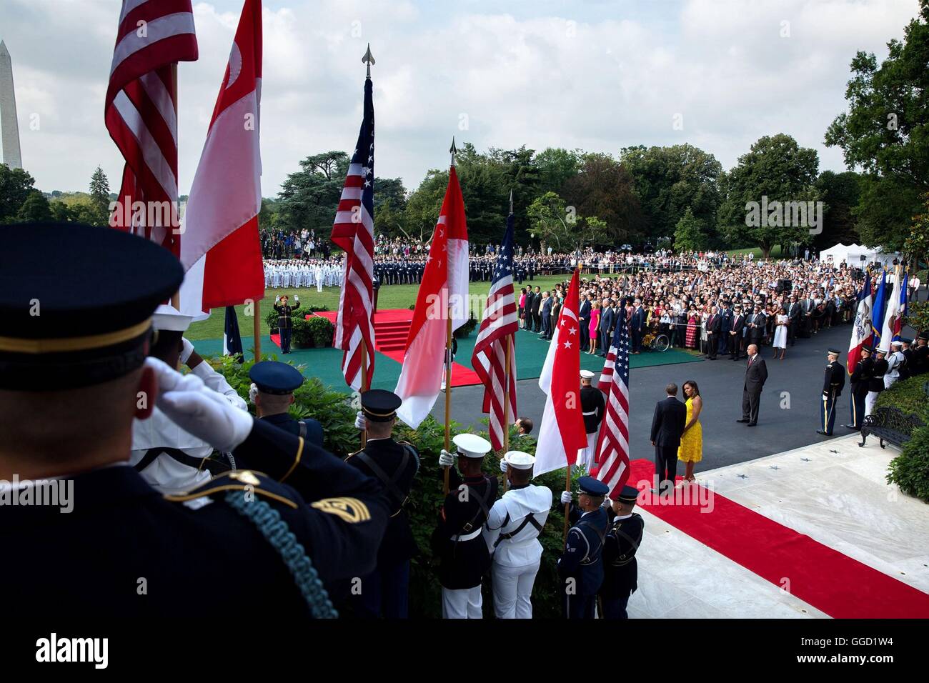 U.S President Barack Obama and First Lady Michelle Obama await the ...