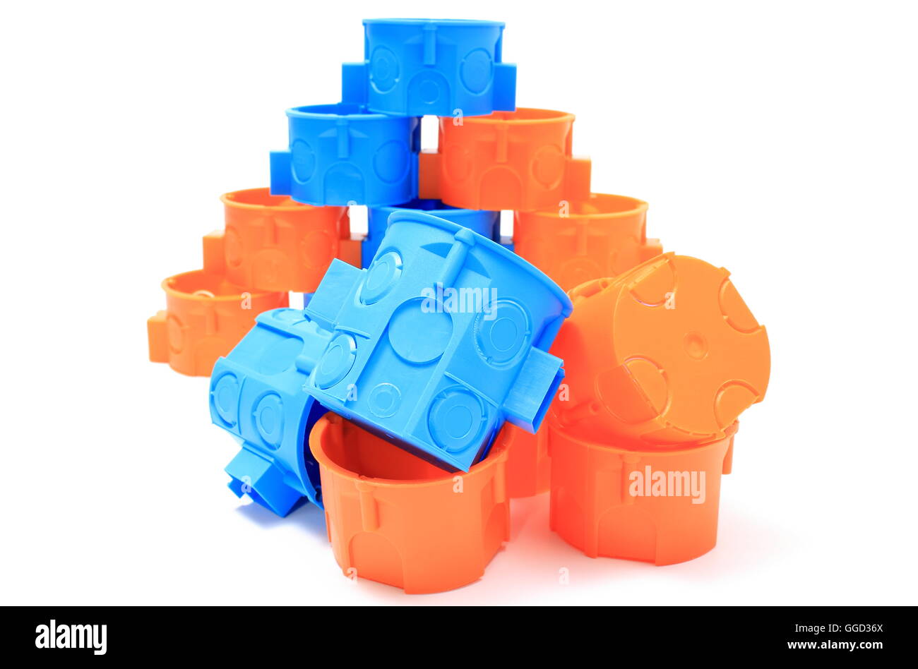 Blue and orange plastic electrical boxes on white background ...