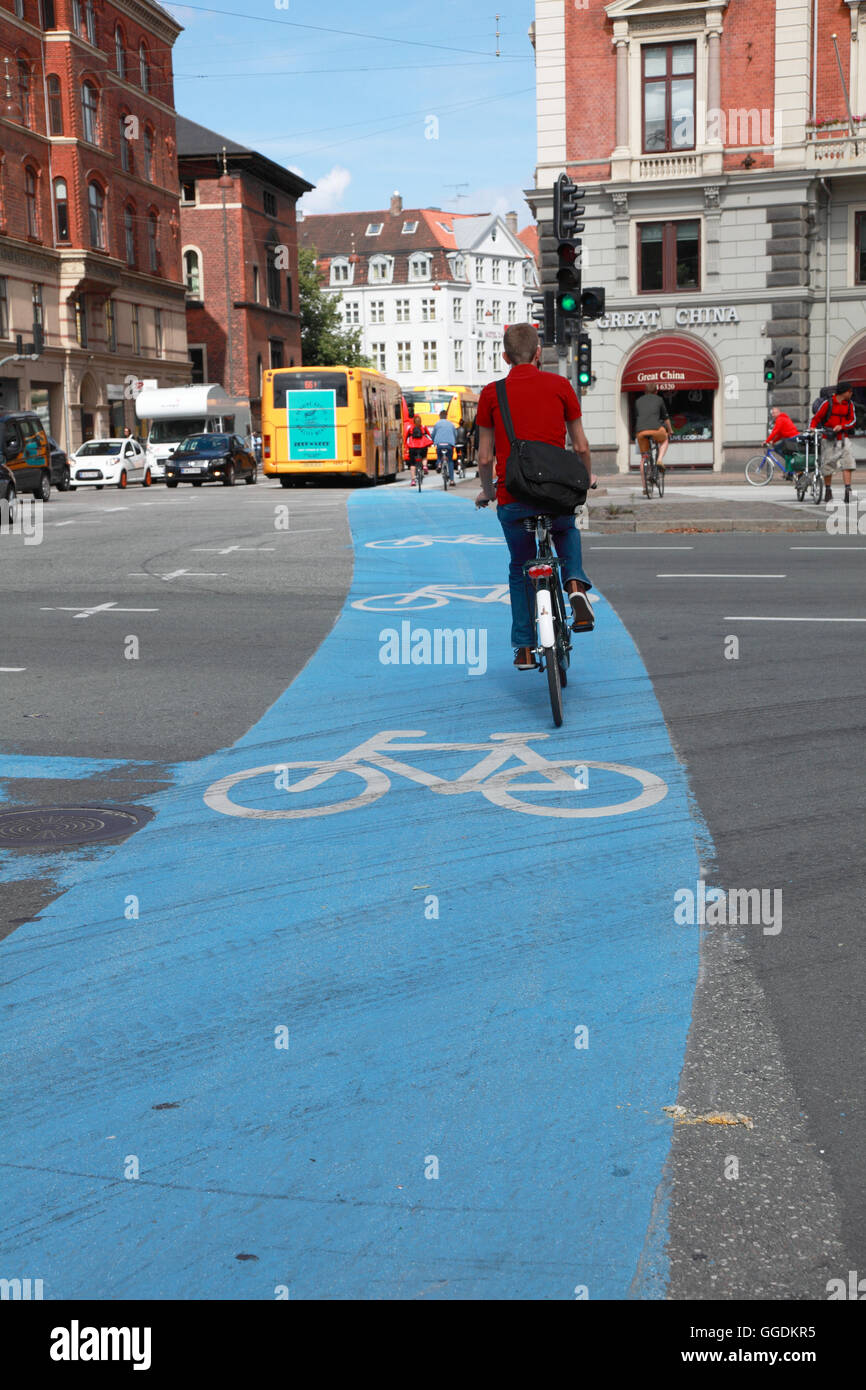 A blue route for cyclists on a busy junction in the centre of ...