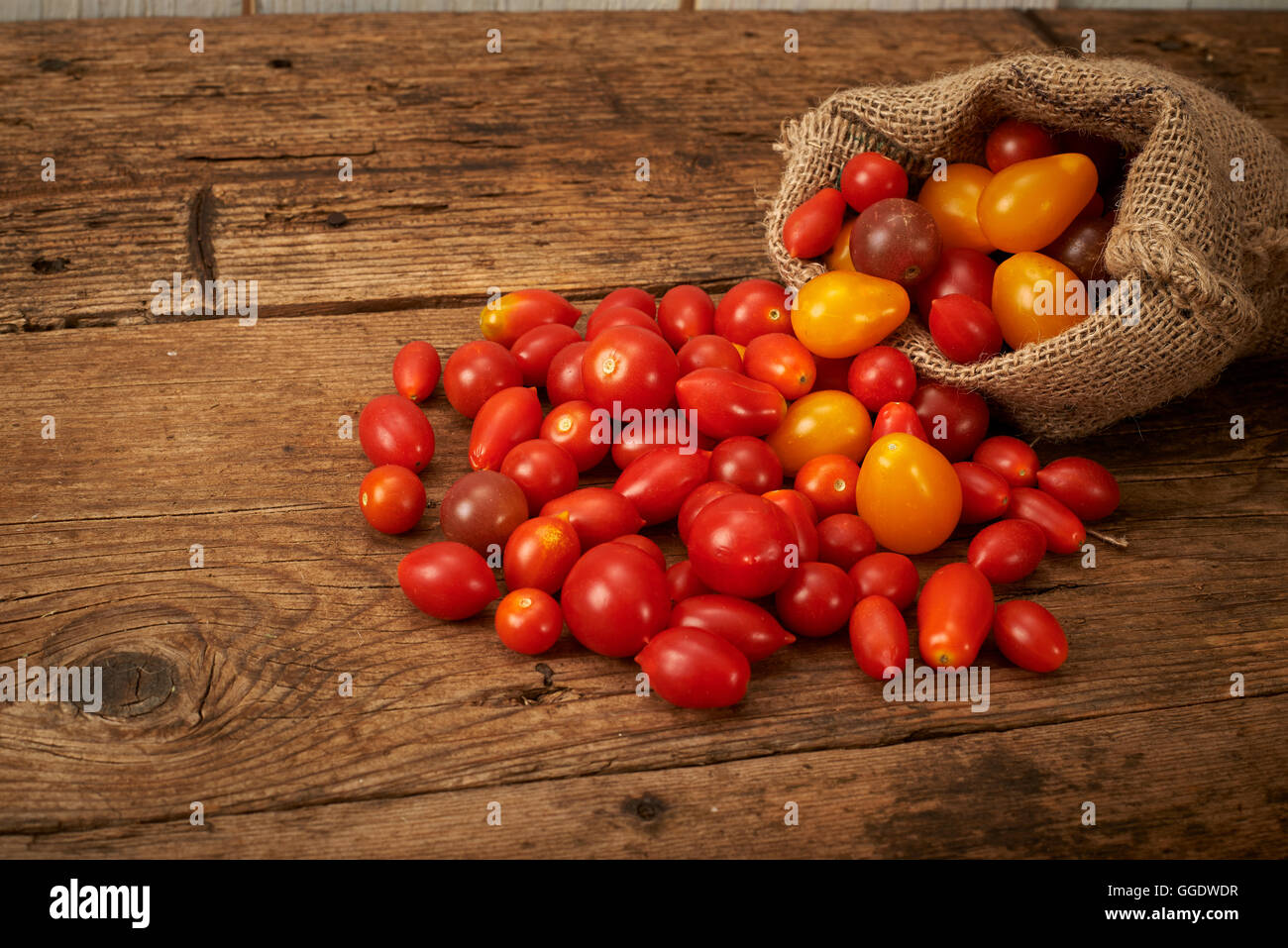 fresh tomato on a wooden kitchen table Stock Photo - Alamy