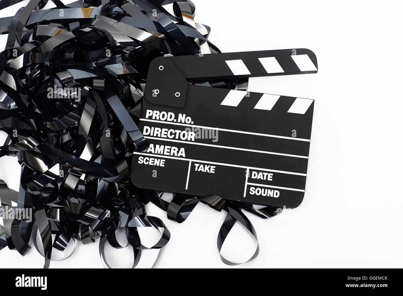 Movie clapper board with video tape on white background Stock Photo - Alamy
