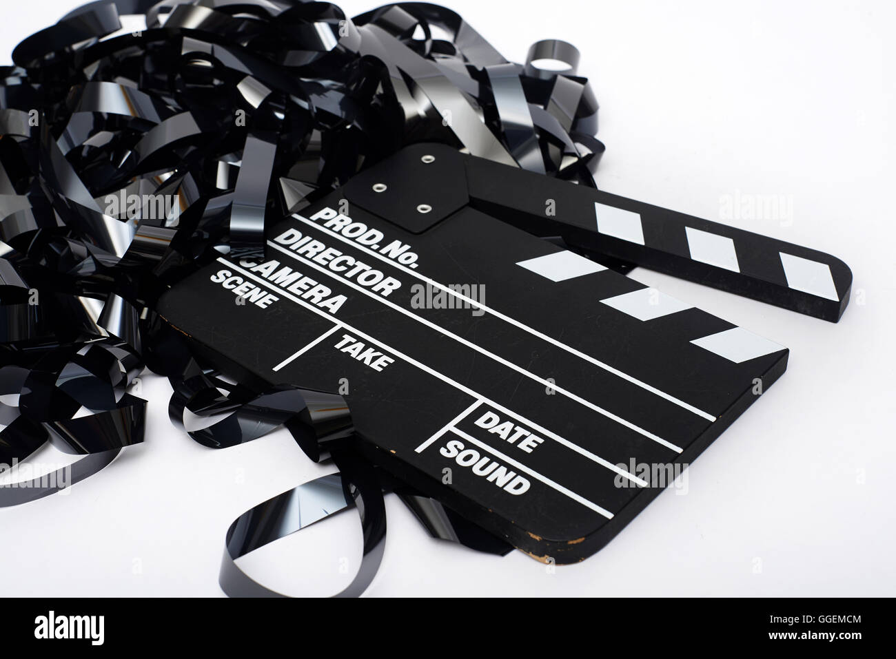 Movie clapper board with video tape on white background Stock Photo - Alamy
