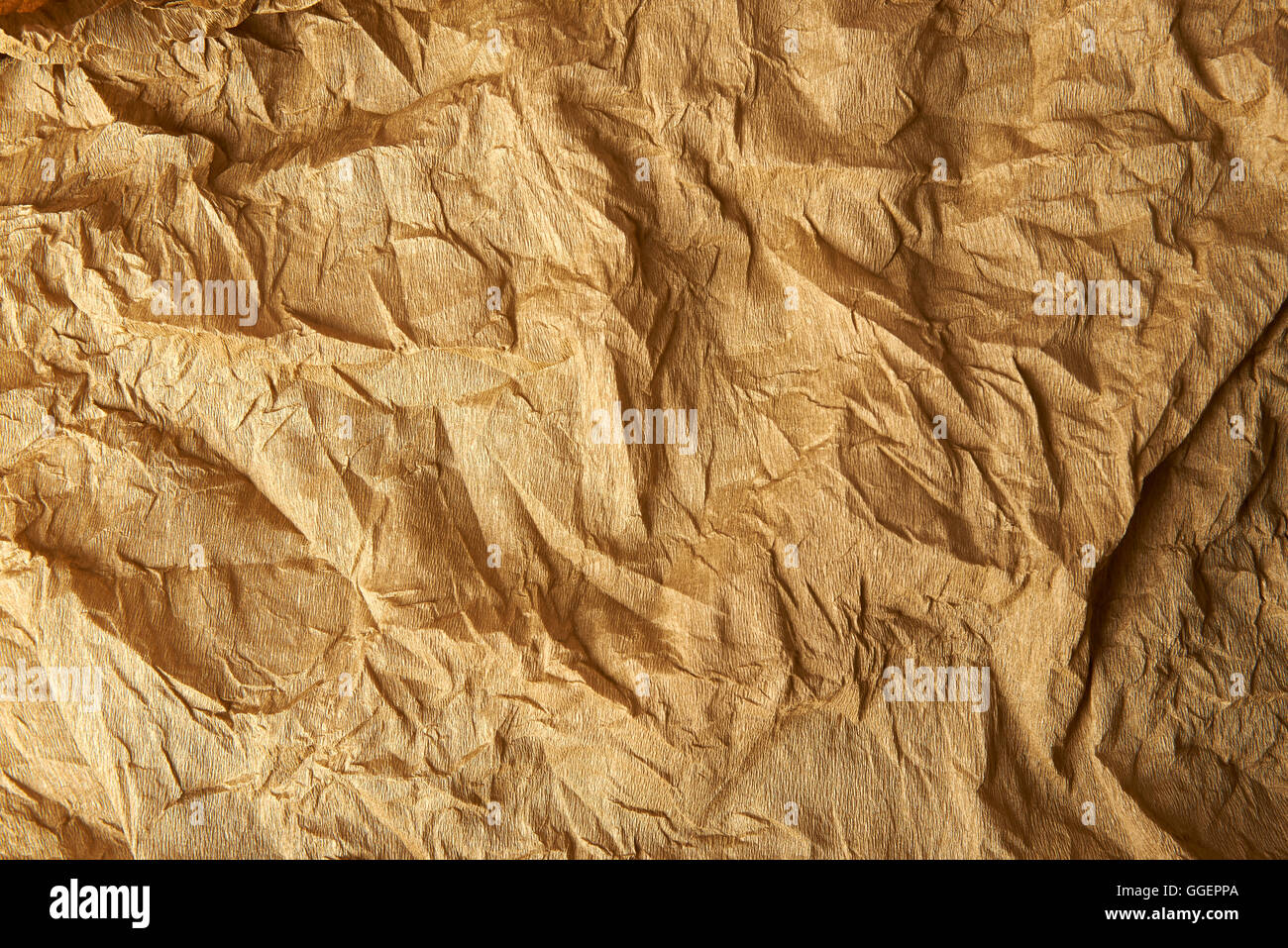 Brown color crumpled paper as a background Stock Photo - Alamy