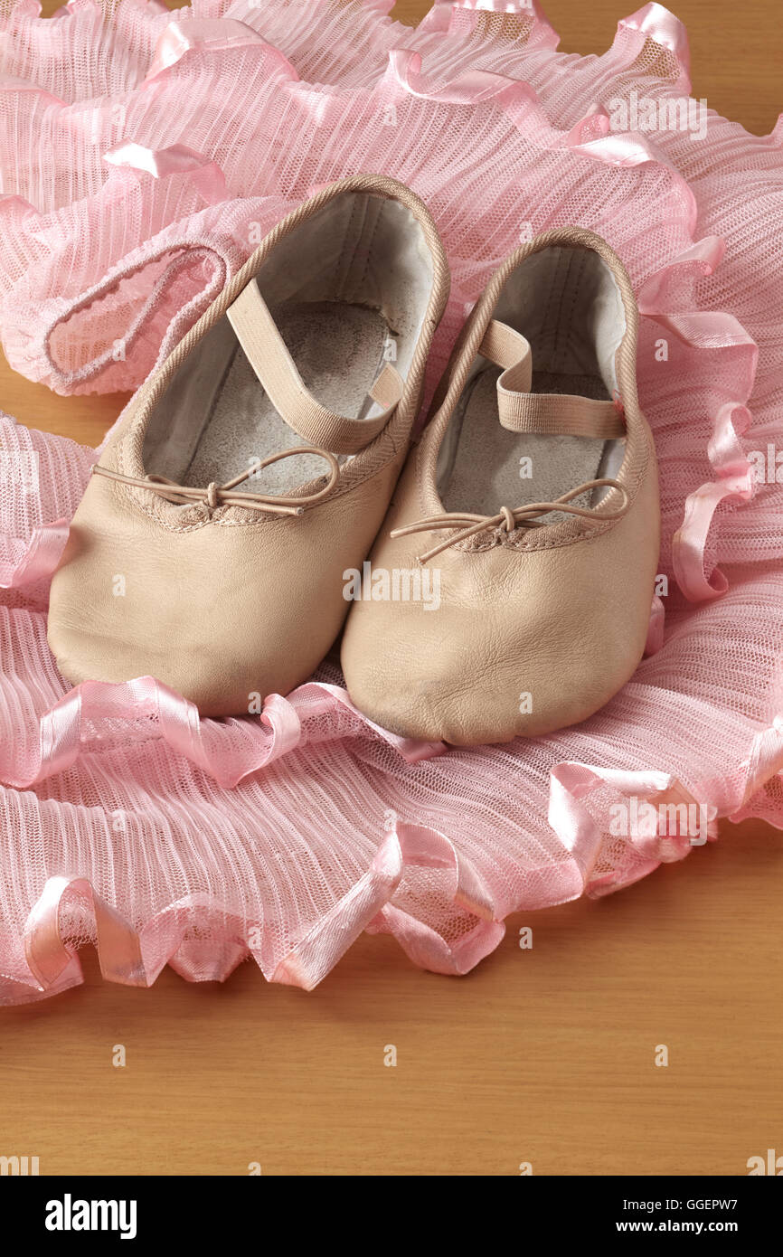 pair of ballet shoes with a pink dress Stock Photo - Alamy