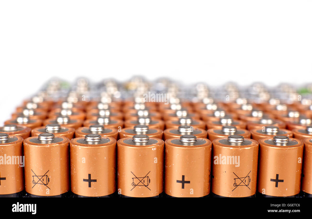 gold batteries in rows with silver tops close up Stock Photo - Alamy