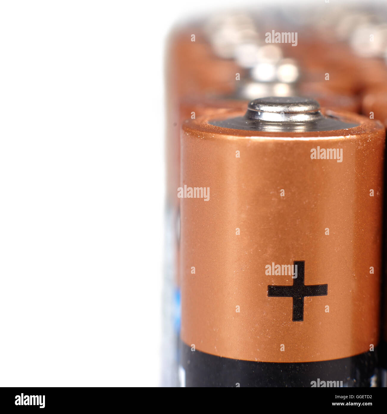 gold batteries in rows with silver tops close up Stock Photo - Alamy