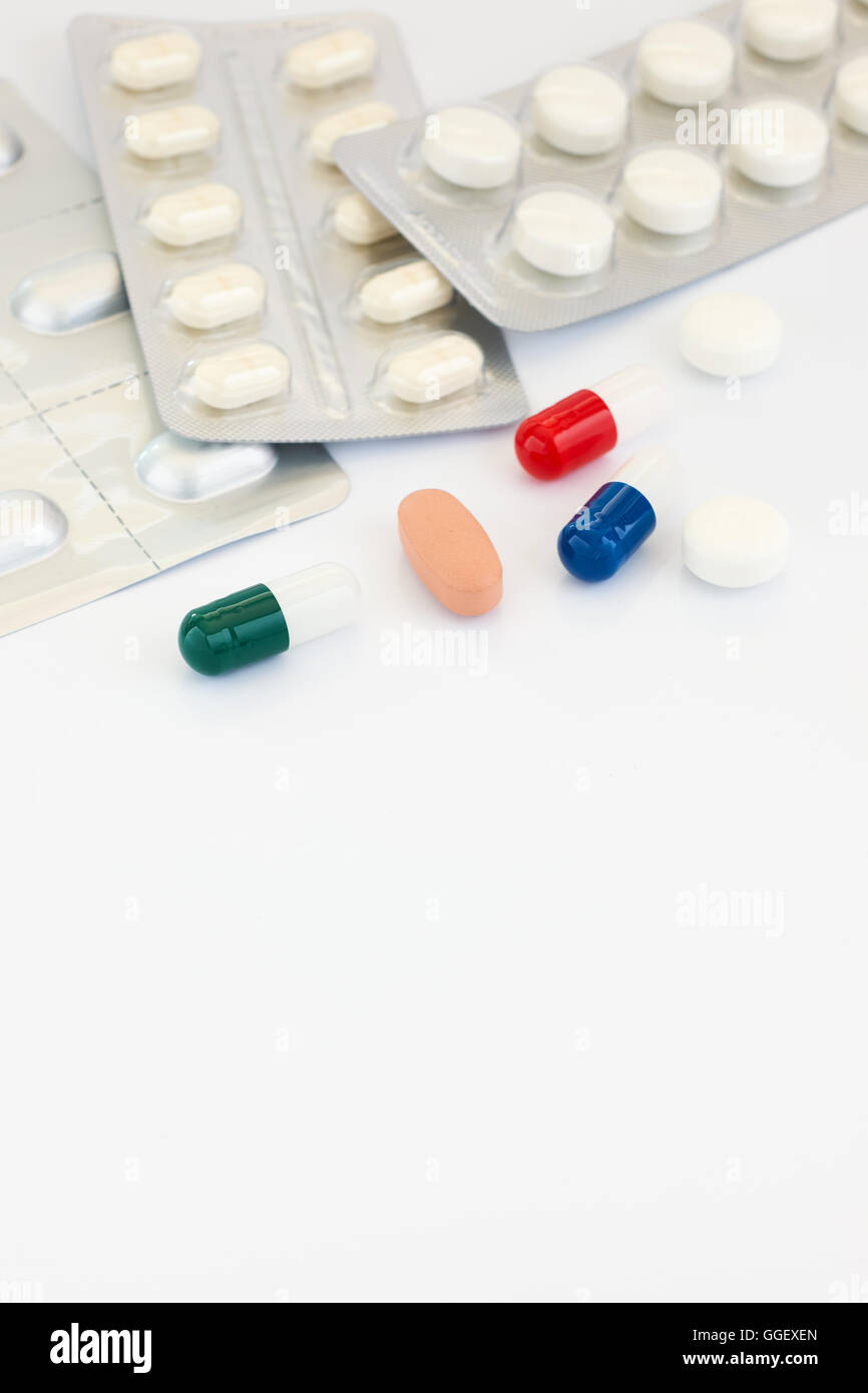 Colored capsules, pills medicines and blister photographed on a white ...