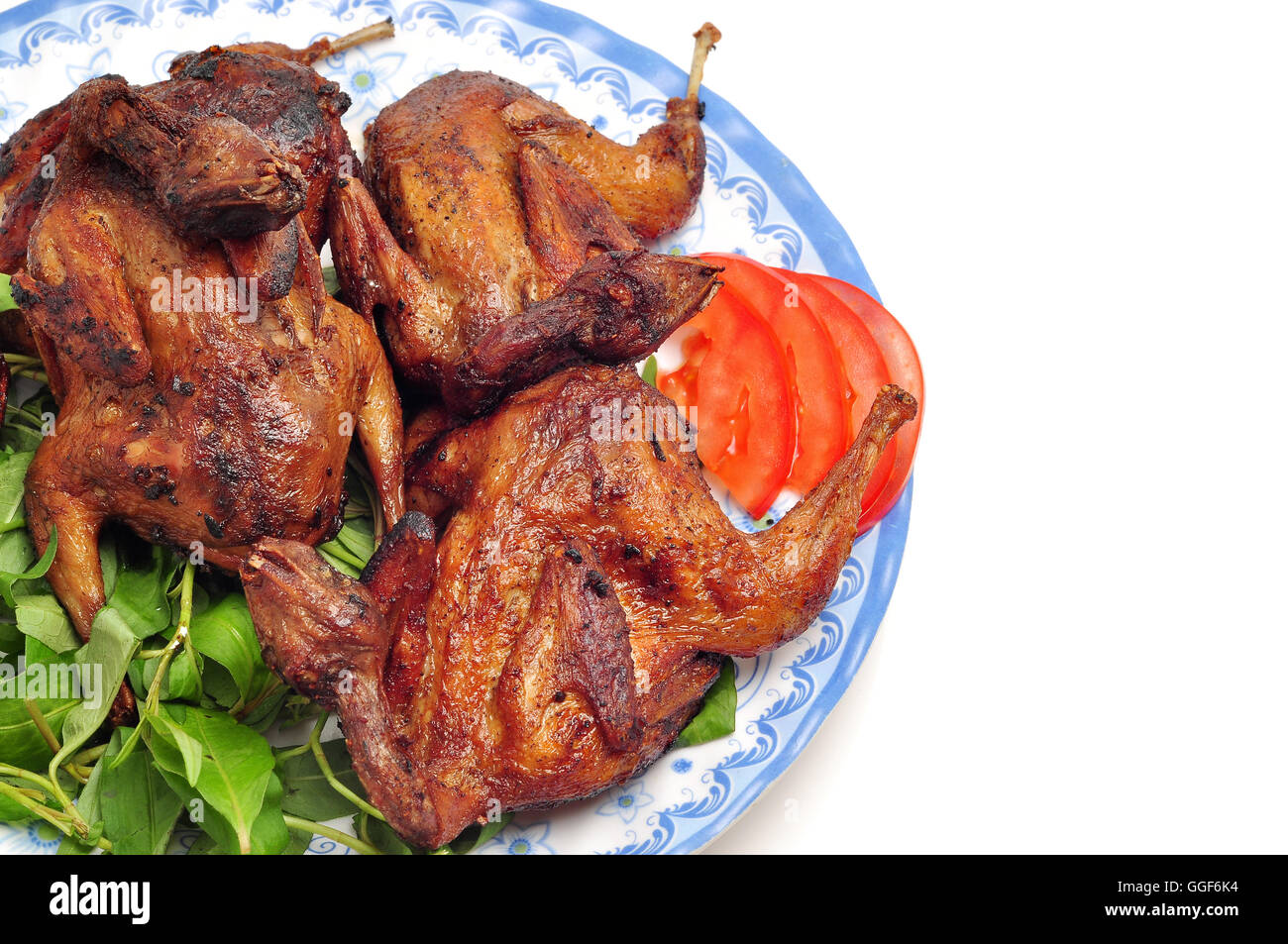 Vietnamese grilled quail on a white background Stock Photo - Alamy