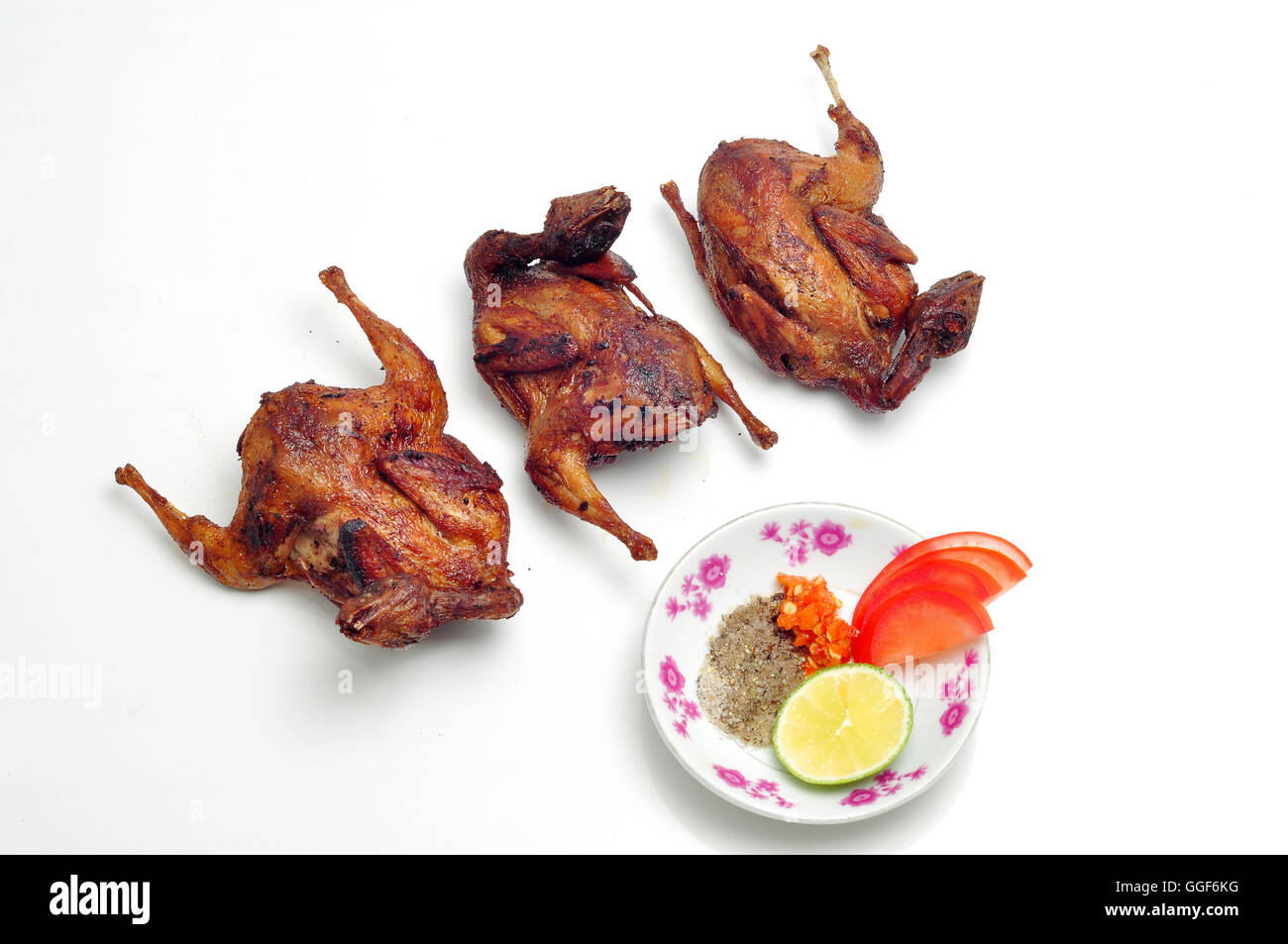 Vietnamese grilled quail on a white background Stock Photo - Alamy