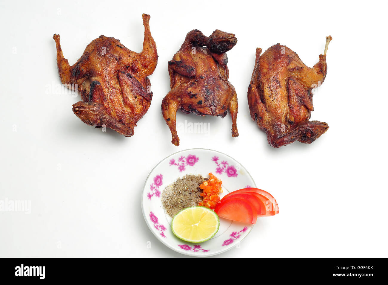 Vietnamese grilled quail on a white background Stock Photo - Alamy