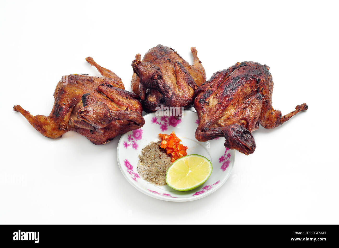 Vietnamese grilled quail on a white background Stock Photo - Alamy