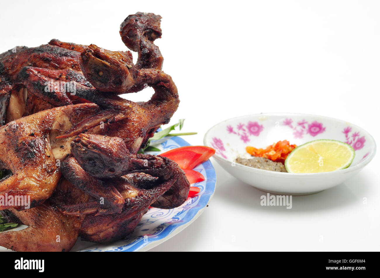 Vietnamese grilled quail on a white background Stock Photo - Alamy