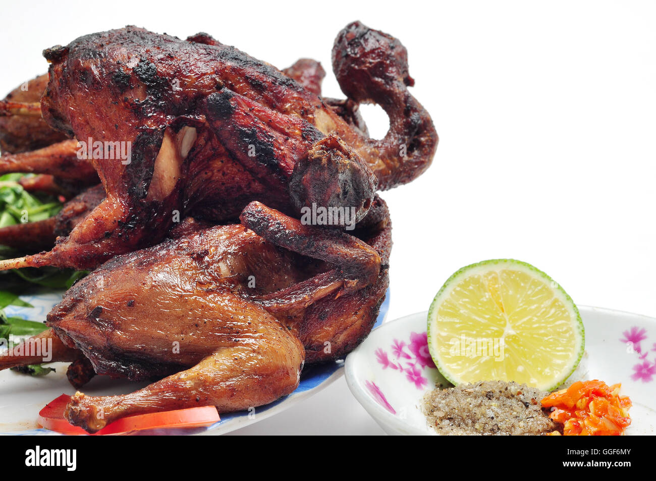 Vietnamese grilled quail on a white background Stock Photo - Alamy