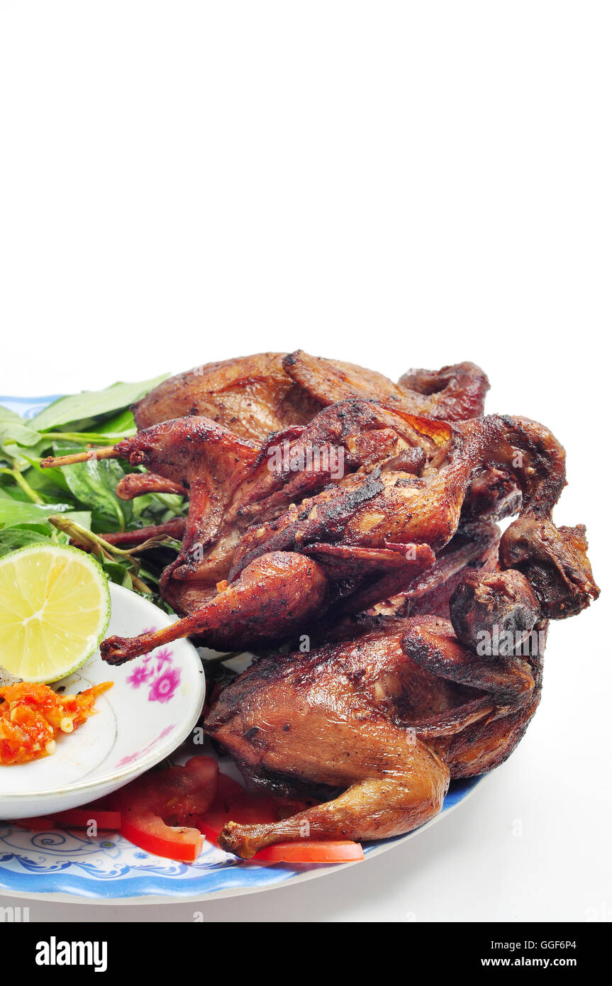 Vietnamese grilled quail on a white background Stock Photo - Alamy