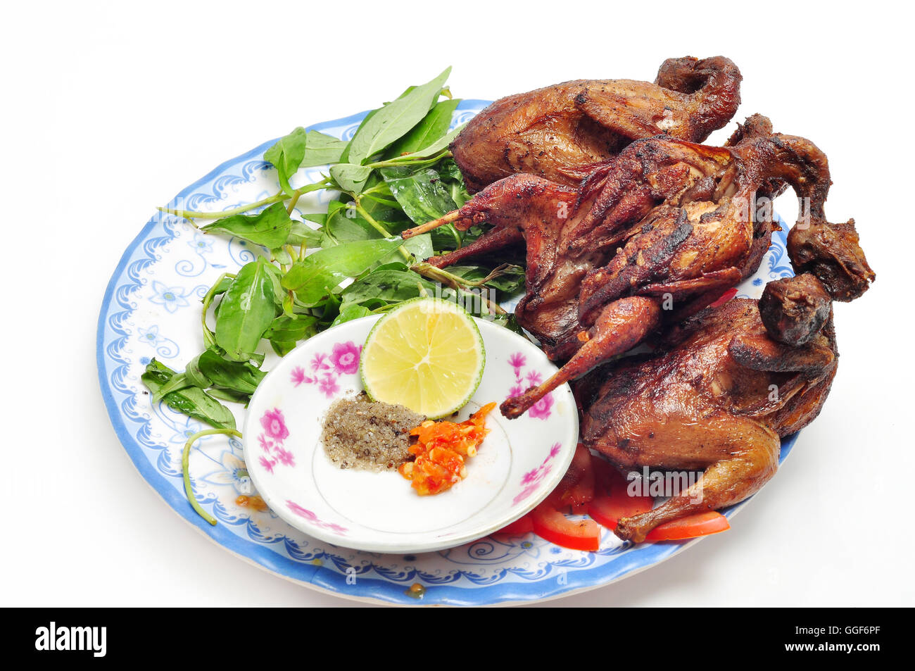Vietnamese grilled quail on a white background Stock Photo - Alamy