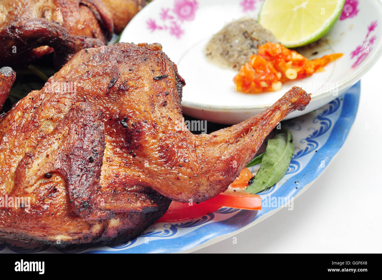 Vietnamese grilled quail on a white background Stock Photo - Alamy