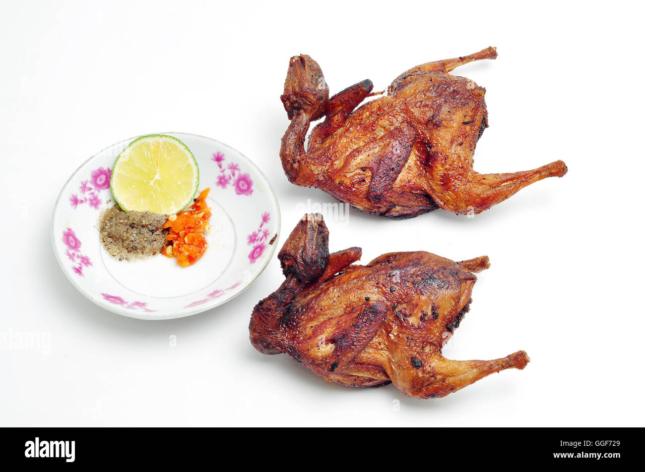 Vietnamese grilled quail on a white background Stock Photo - Alamy
