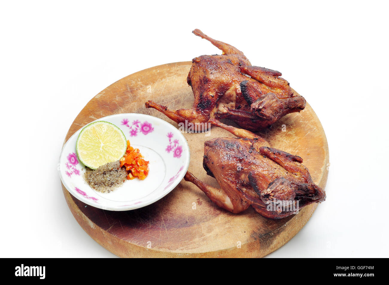 Vietnamese grilled quail on a white background Stock Photo - Alamy