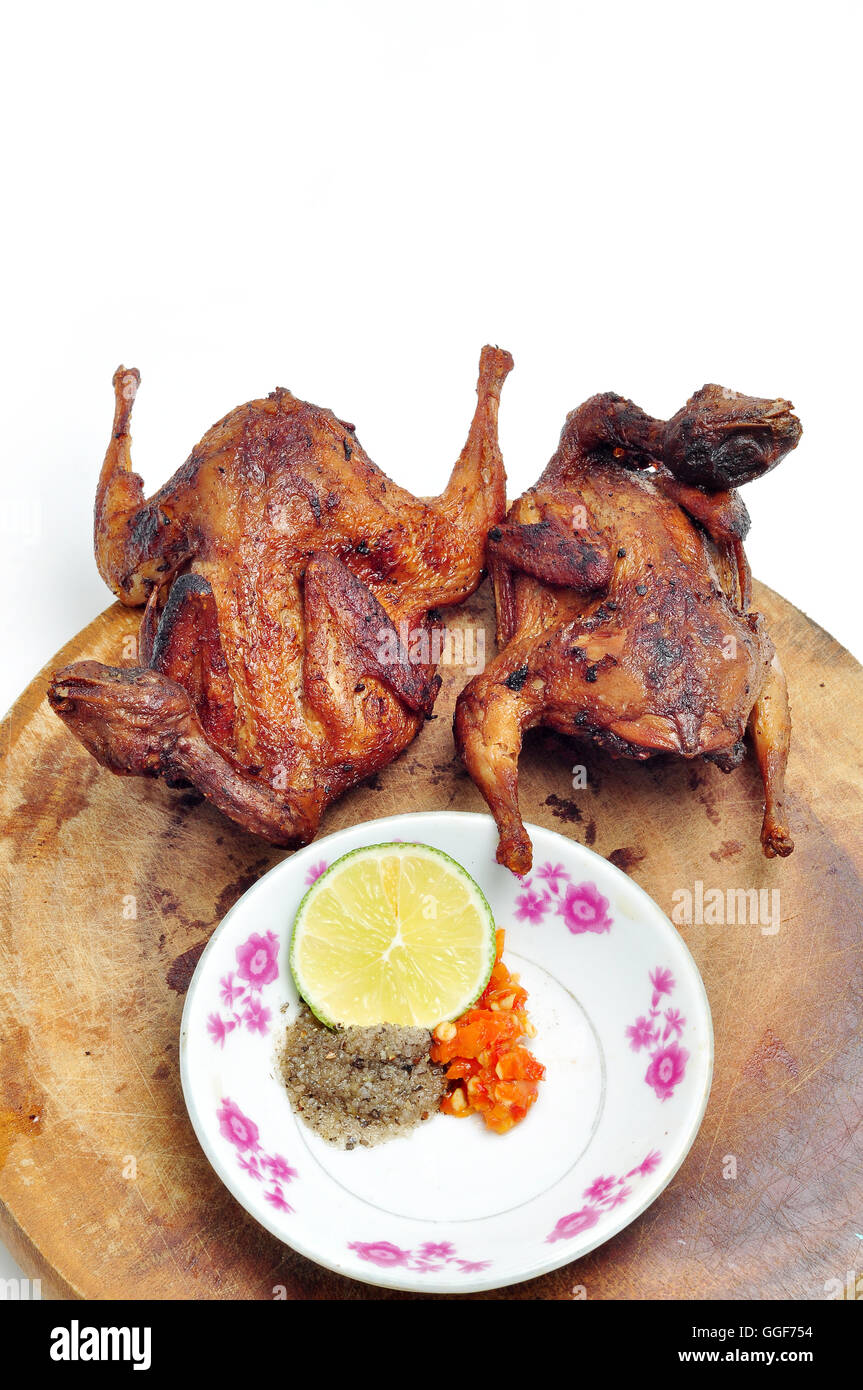 Vietnamese grilled quail on a white background Stock Photo - Alamy
