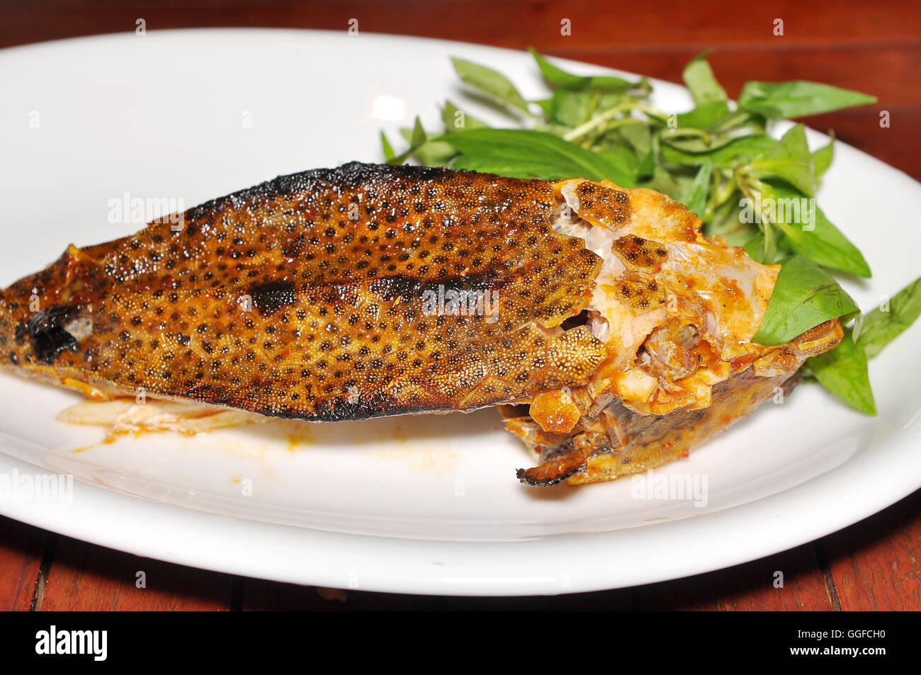 Grilled boxfish on the dish in the restaurant Stock Photo - Alamy
