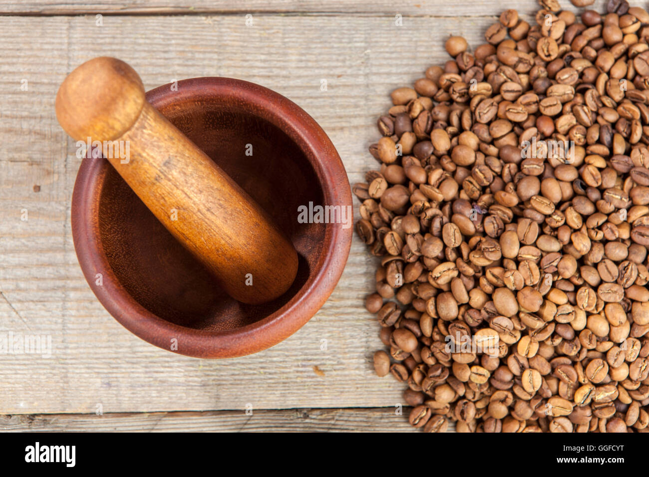 Mortar and pestle with brown coffee and coffee beans Stock Photo - Alamy