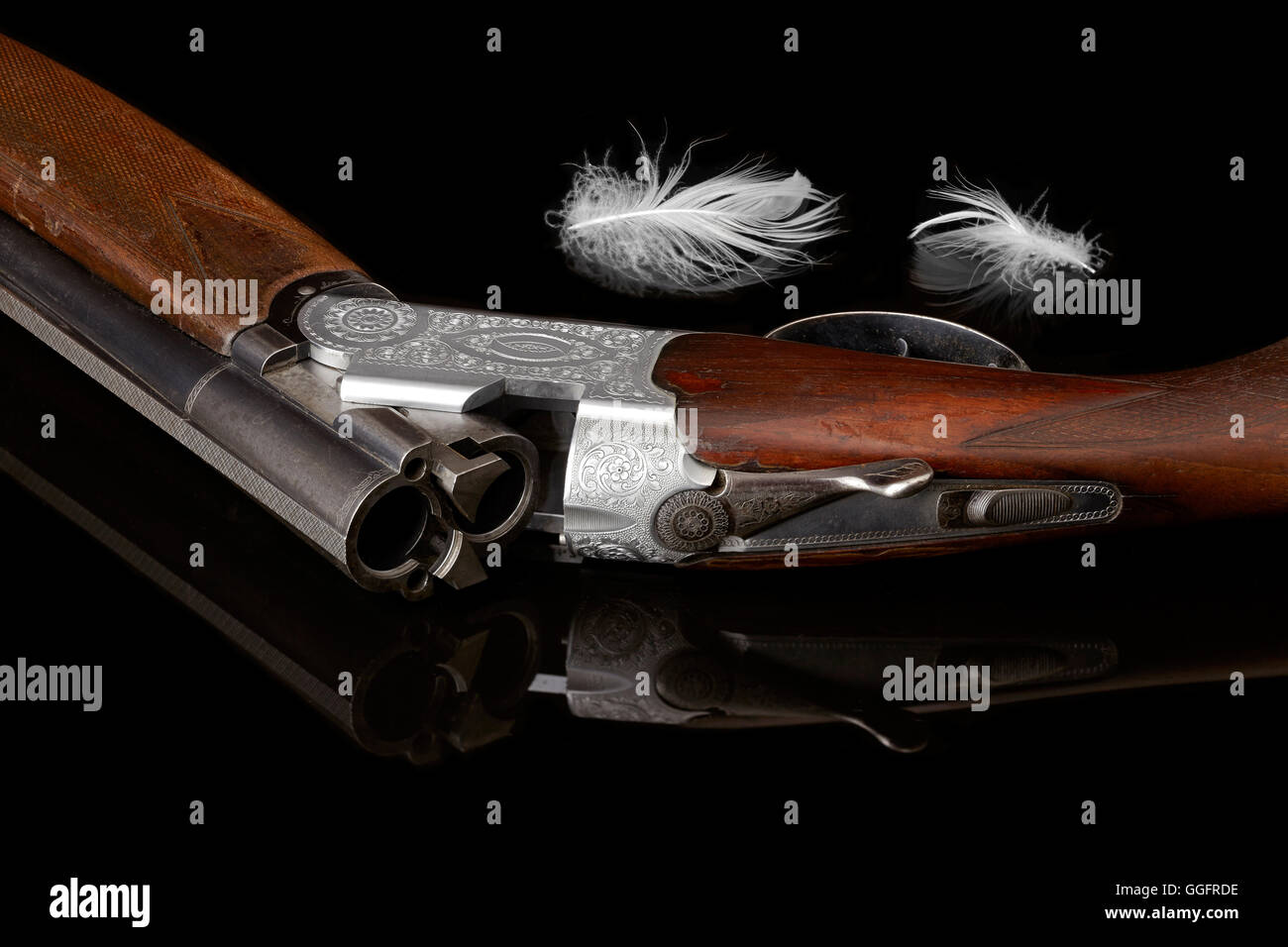 hunting gun with a white feather Stock Photo - Alamy