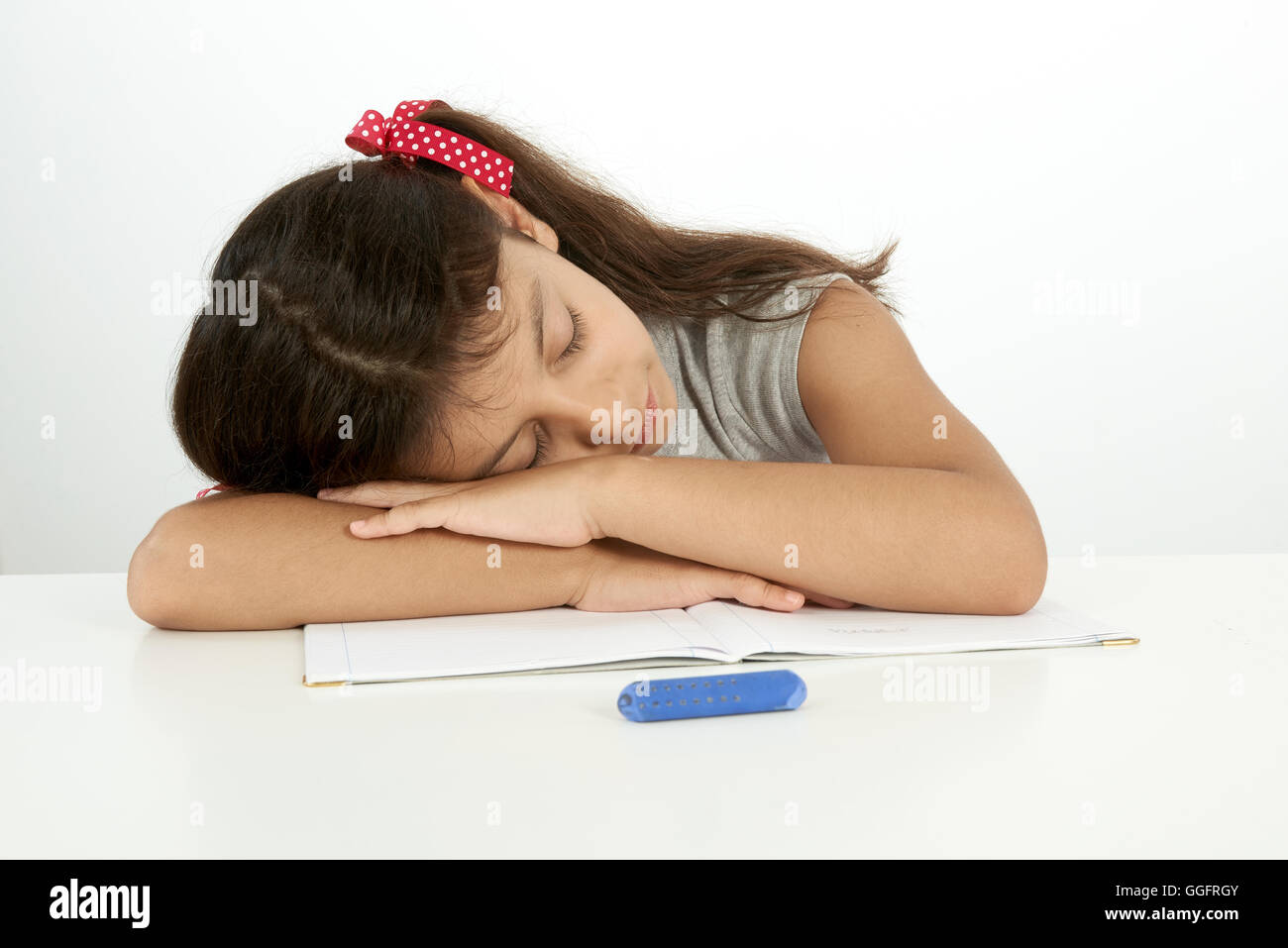 Bored student laying her head on the desk Stock Photo - Alamy