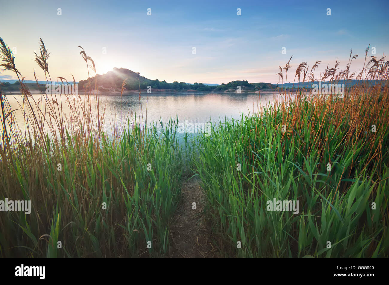 River lake and spring green hill Stock Photo - Alamy